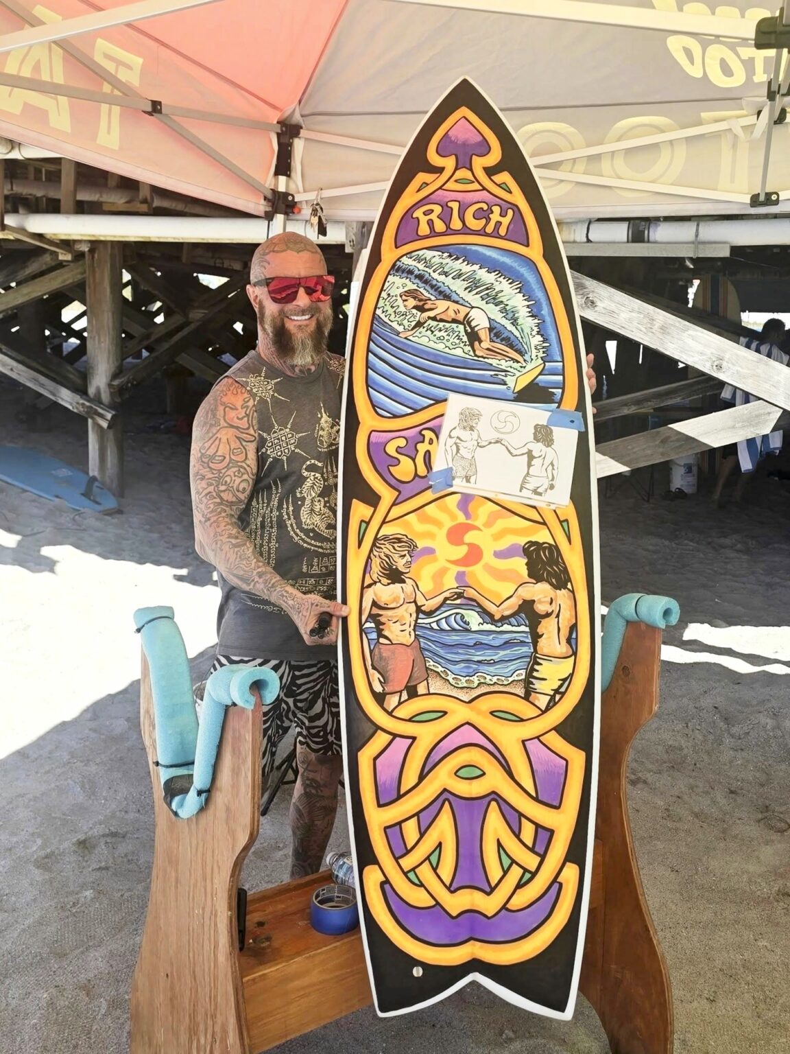Tattoo artist Mark Longenecker with the board he painted honoring Rich ...